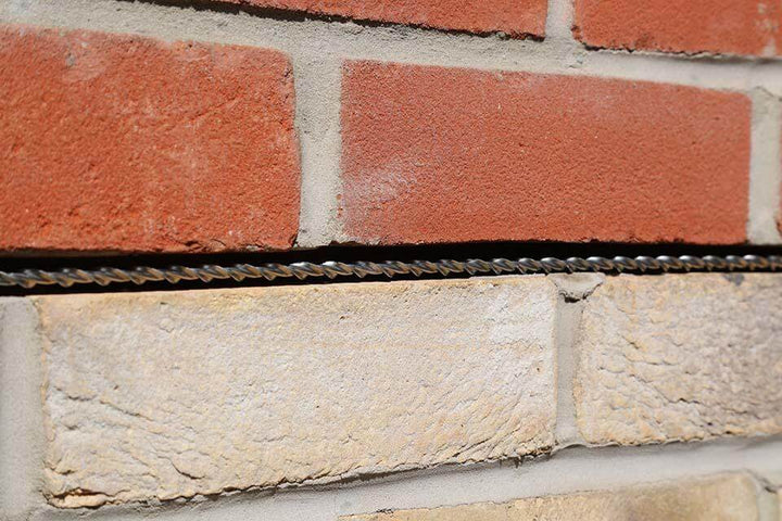 Masonry arch circumferential beaming and pinning using reinforcing rods ...